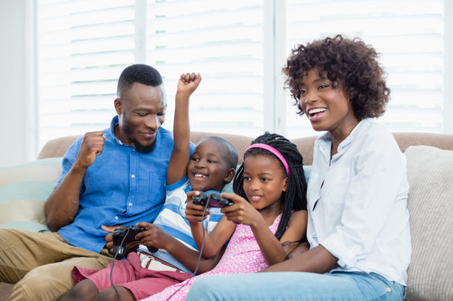 Happy family playing video game - LearningWorks for Kids